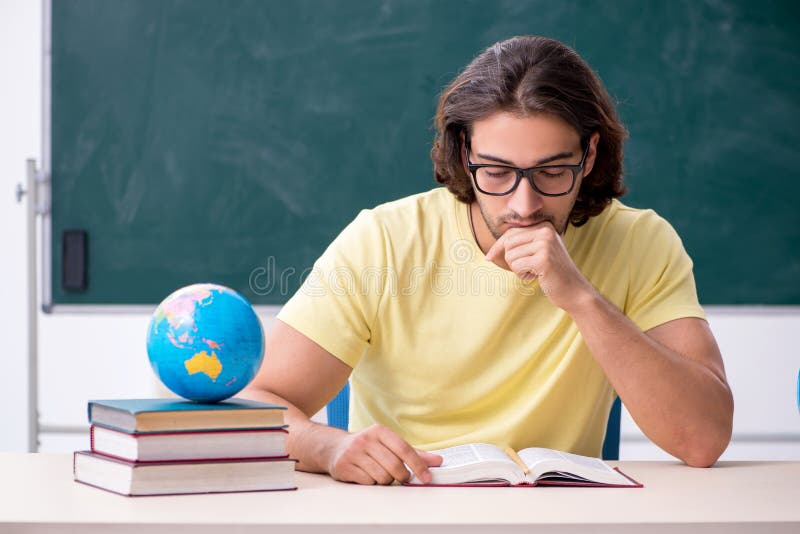 Young Male Geography Teacher in Front of Blackboard Stock Photo - Image ...