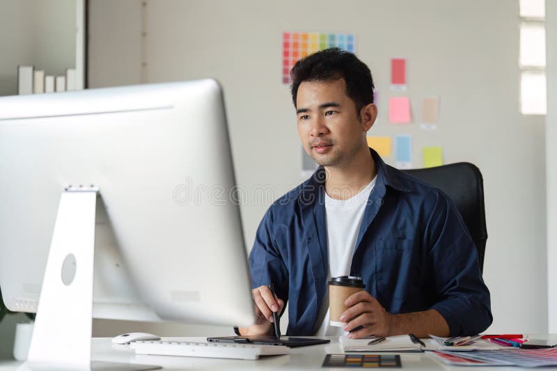 Young Male Graphic Designer Focused on Creative Work at Computer in ...