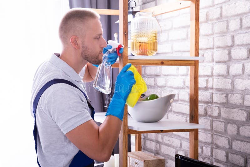 Young Male Janitor Cleaning Shelf Stock Image - Image of indoors, human ...