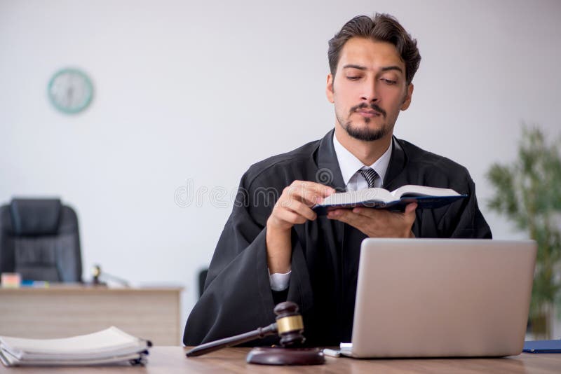 Young Male Judge Reading Book in the Courthouse Stock Photo - Image of ...