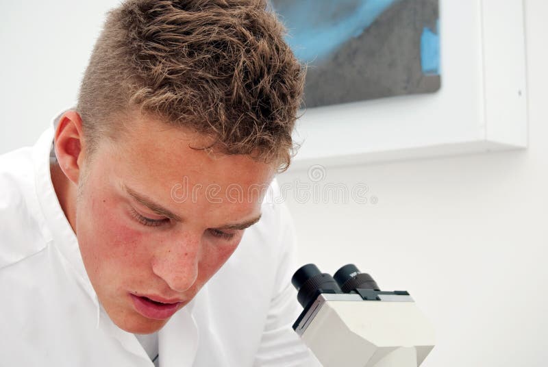 Young Male Lab Technician Looks at Results Stock Image - Image of body ...