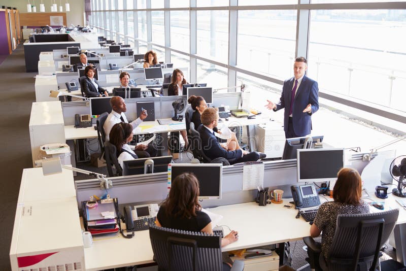 Young Male Manager Addressing Workers in Open Plan Office Stock Image ...