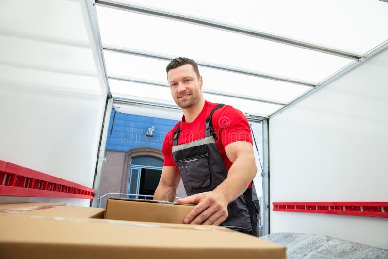 Young Male Mover Arranging the Boxes Inside the Van Stock Photo - Image ...