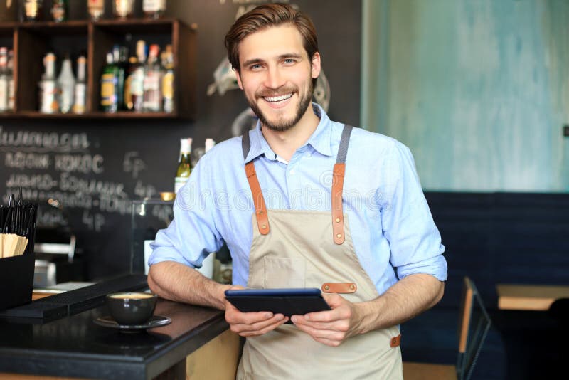 Young Male Owner Using Digital Tablet while Standing in Cafe Stock ...