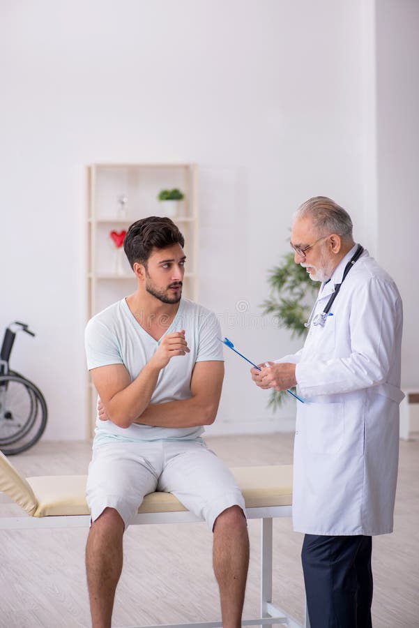 Young Male Patient Visiting Old Male Doctor Stock Photo - Image of ...