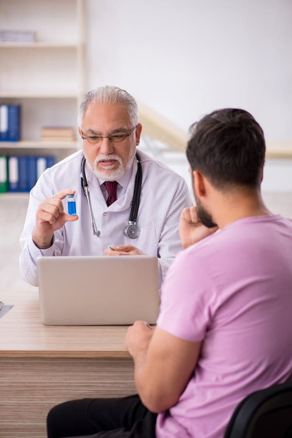 Young Male Patient Visiting Old Male Doctor Stock Photo - Image of care ...