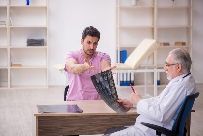 Young Male Patient Visiting Old Male Doctor Radiologist Stock Photo ...