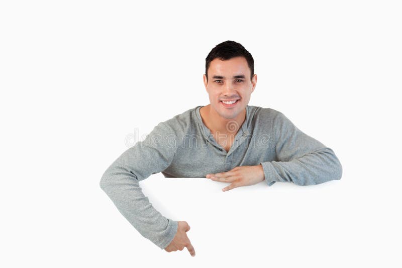Young Male Pointing at Banner Below Him Stock Photo - Image of curious ...
