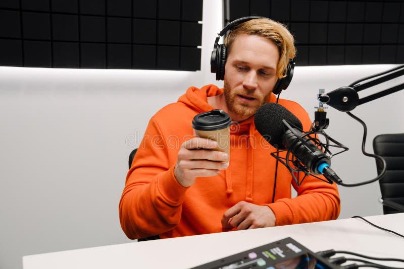 Young Male Radio Host Using Microphone while Broadcasting in Studio ... Young Male Radio Host Using Microphone while Broadcasting in Studio ...