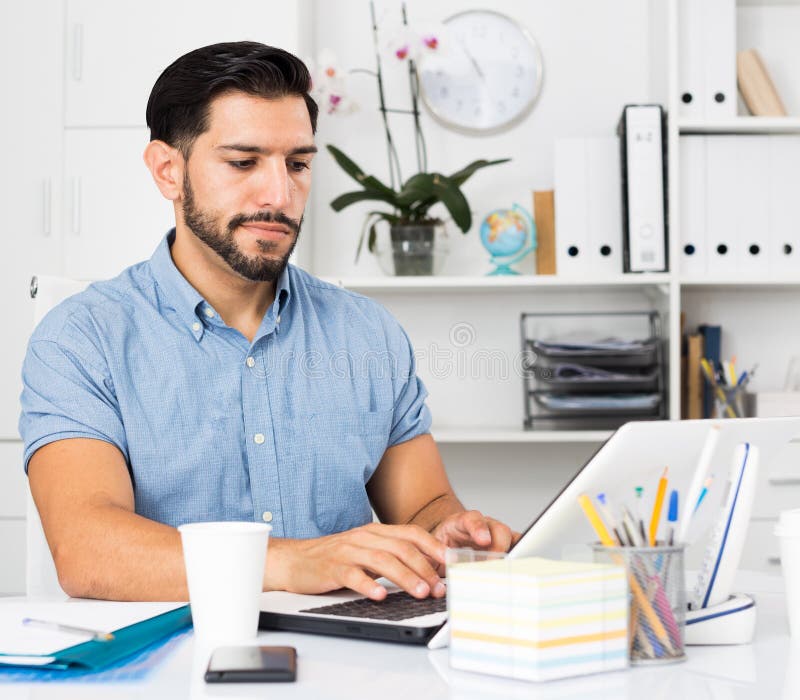 Young Male is Reading Documents and Looking in Laptop Stock Image ...