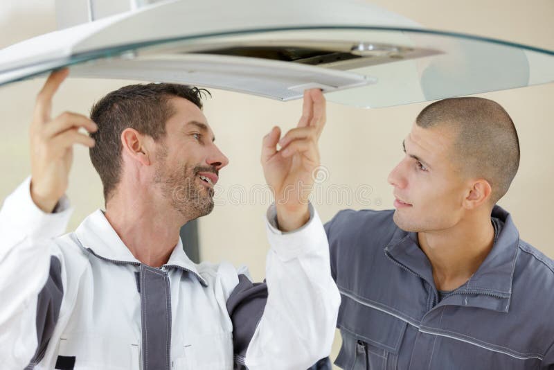 Two Male Repairmen Working at Workshop Stock Photo - Image of disorder ...