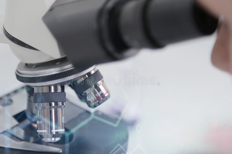 Young Male Male Scientist Looking through a Microscope in a Labo Stock ...