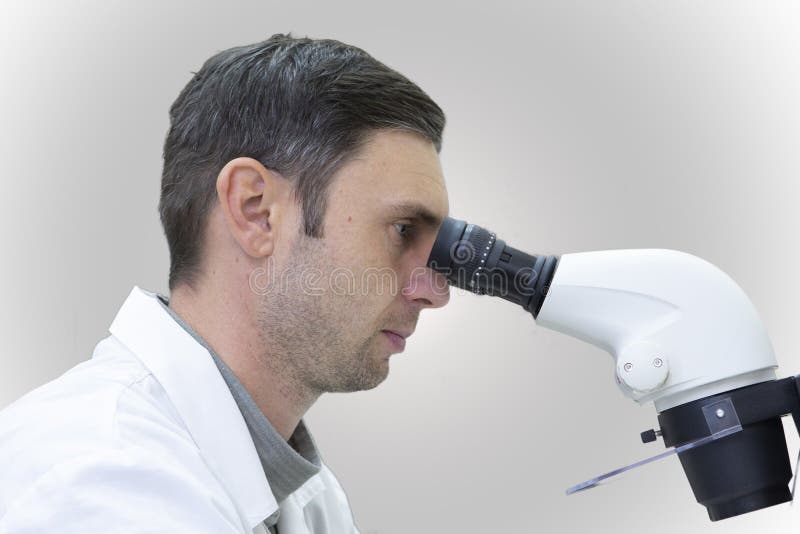 Young Male Scientist Works with a Microscope in a Science Lab Stock ...