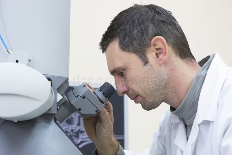 Young Male Scientist Works with a Microscope in a Science Lab Stock ...