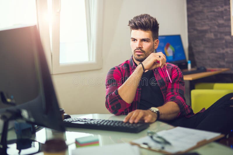 Young Male Sitting at Desk in Office Stock Photo - Image of corporate ...
