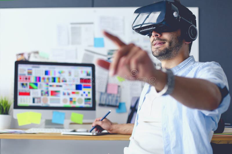 Young Male Software Programmer Testing A New App With 3d Virtual Reality Glasses In Office