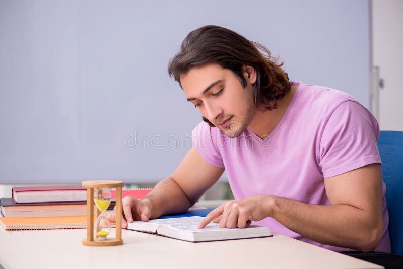 Young Male Student in the Classroom at Time Management Concept Stock ...