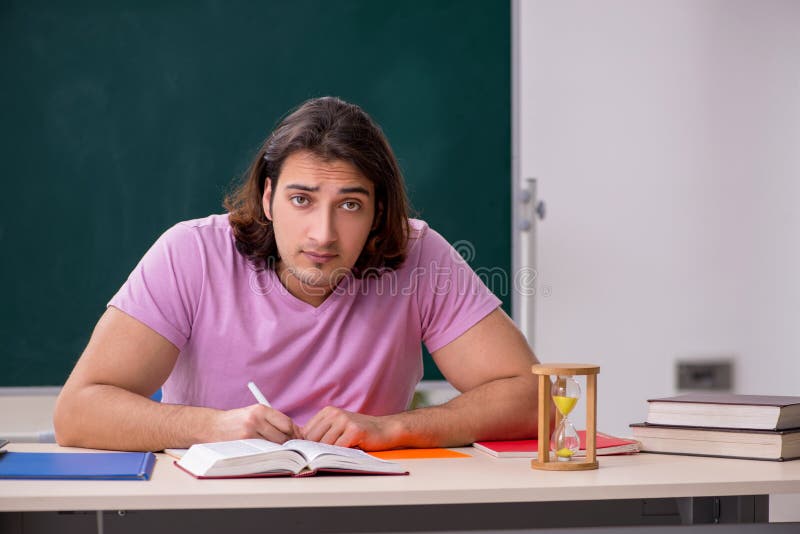 Young Male Student in the Classroom at Time Management Concept Stock ...