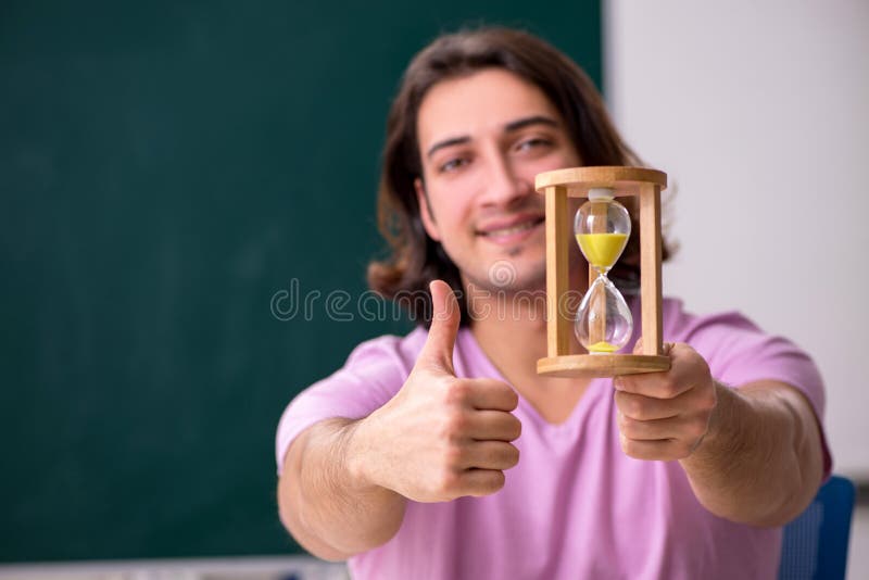 Young Male Student in the Classroom at Time Management Concept Stock ...