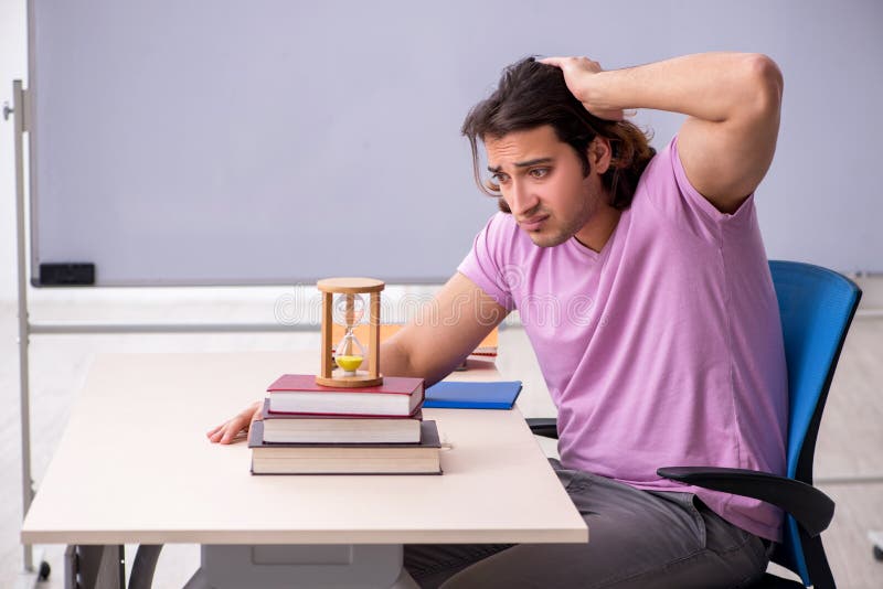 Young Male Student in the Classroom at Time Management Concept Stock ...