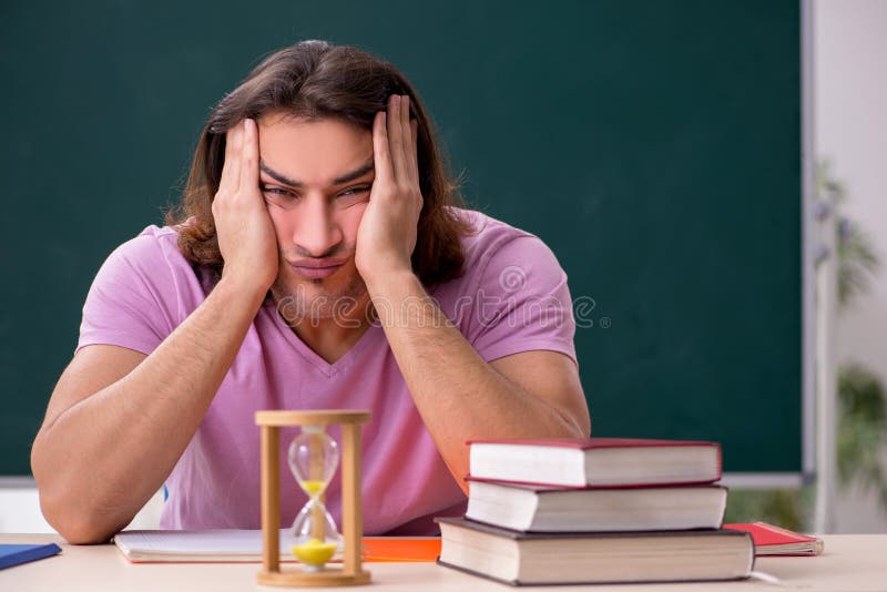 Young Male Student in the Classroom at Time Management Concept Stock ...