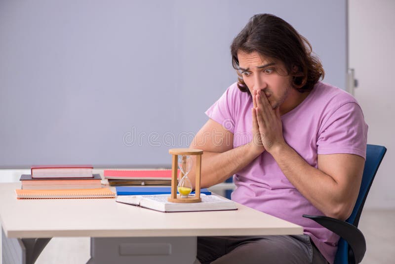 Young Male Student in the Classroom at Time Management Concept Stock ...