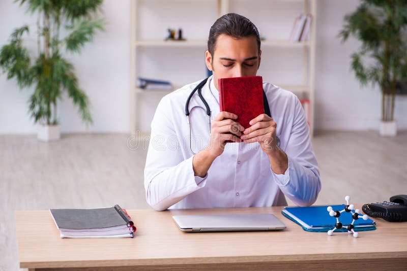 Young Male Student Doctor Reading Book in the Clinic Stock Photo ...