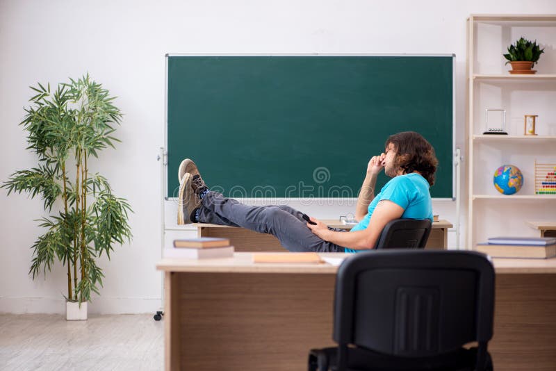 Young Male Student in Front of Green Board Stock Photo - Image of ...