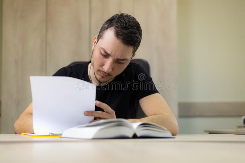 Male Student in the Learning Process with a Pen and Abstract Stock ...