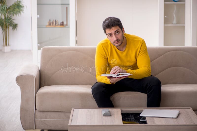 Young Male Student Reading Book at Home Stock Photo - Image of high ...