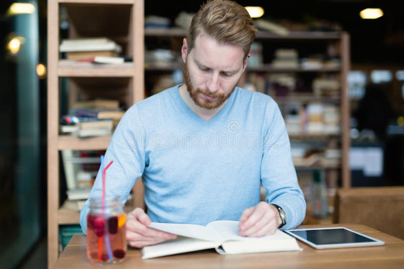 Young Male Student Reading in Coffee Shop Stock Photo - Image of ... Young Male Student Reading in Coffee Shop Stock Photo - Image of ...