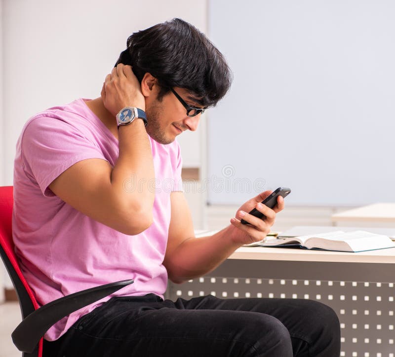 Young Male Student Sitting in the Class Stock Photo - Image of desk ...