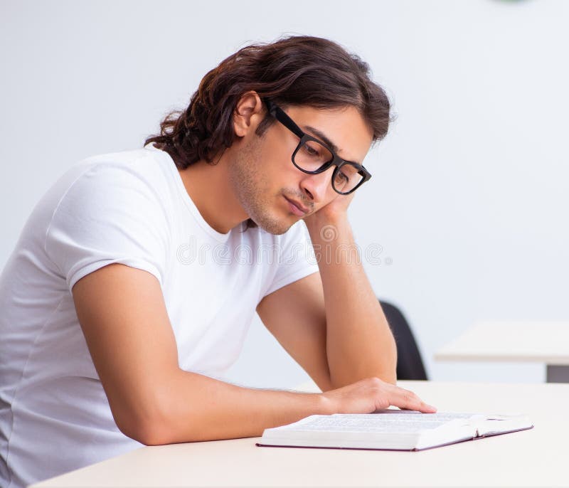 Young Male Student Sitting in the Classroom Stock Image - Image of ... Young Male Student Sitting in the Classroom Stock Image - Image of ...