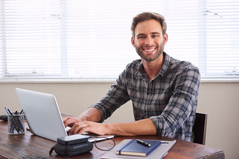 Young Male Student Smiling at Camera while Working on Assignment Stock ...