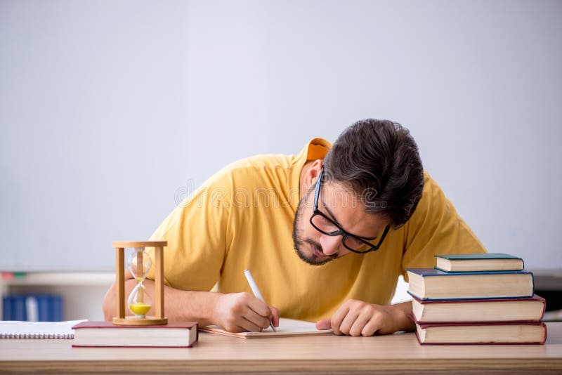 Young Male Student in Time Management Concept Stock Photo - Image of ...