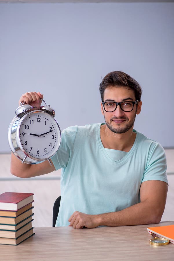 Young Male Student in Time Management Concept in the Classroom Stock ...