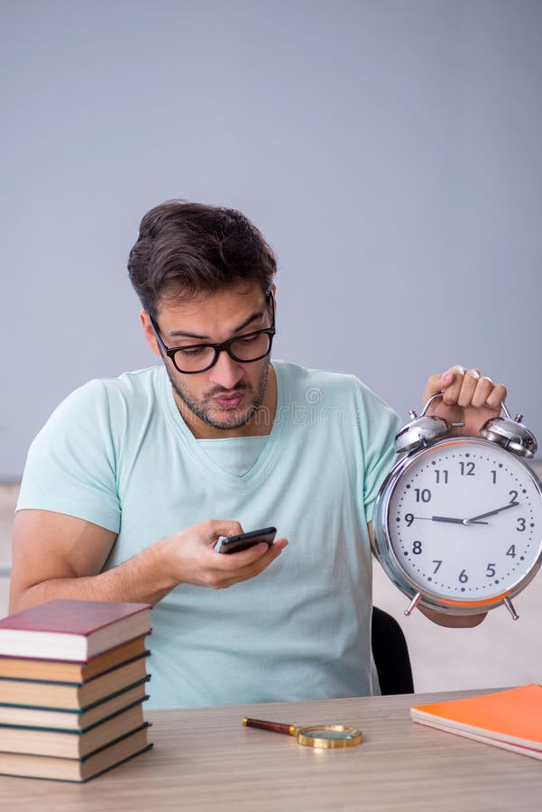 Young Male Student in Time Management Concept in the Classroom Stock ...