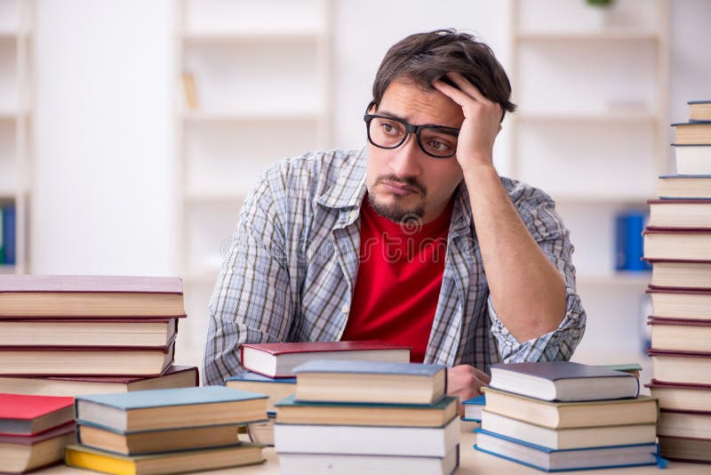 Young Male Student and Too Many Books in the Classroom Stock Image ...