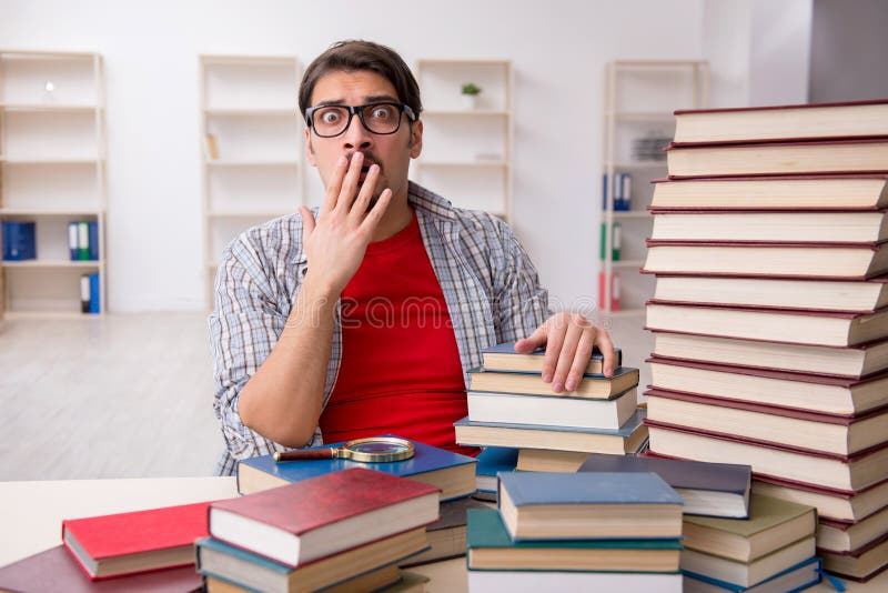 Young Male Student and Too Many Books in the Classroom Stock Image ...