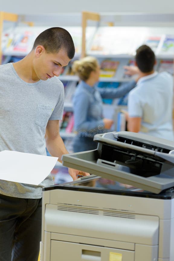 Young Male Student Using Photocopier Stock Image - Image of cropped ...