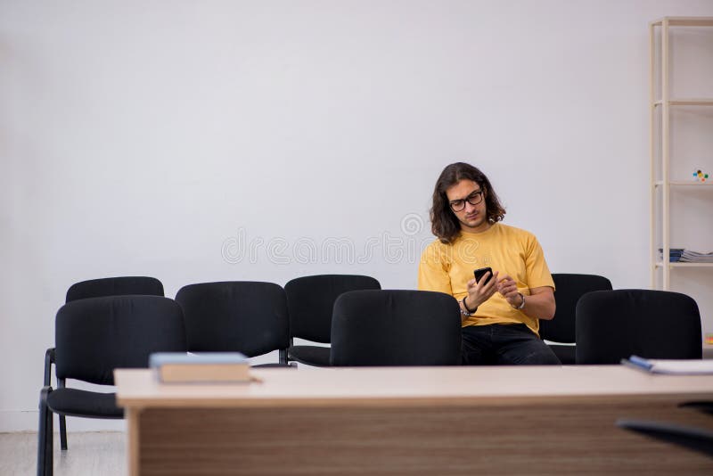 Young Male Student Waiting for Teacher in the Classroom Stock Photo ...