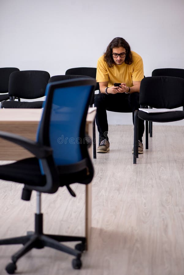 Young Male Student Waiting for Teacher in the Classroom Stock Photo ...