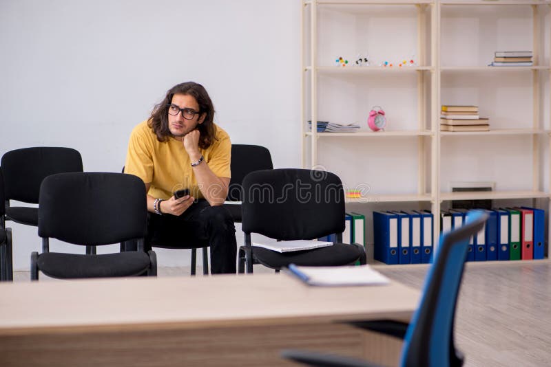 Young Male Student Waiting for Teacher in the Classroom Stock Image ...