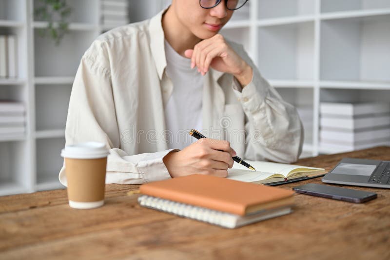 Young Male Student Writing and Taking Note on Notebook Stock Photo ...