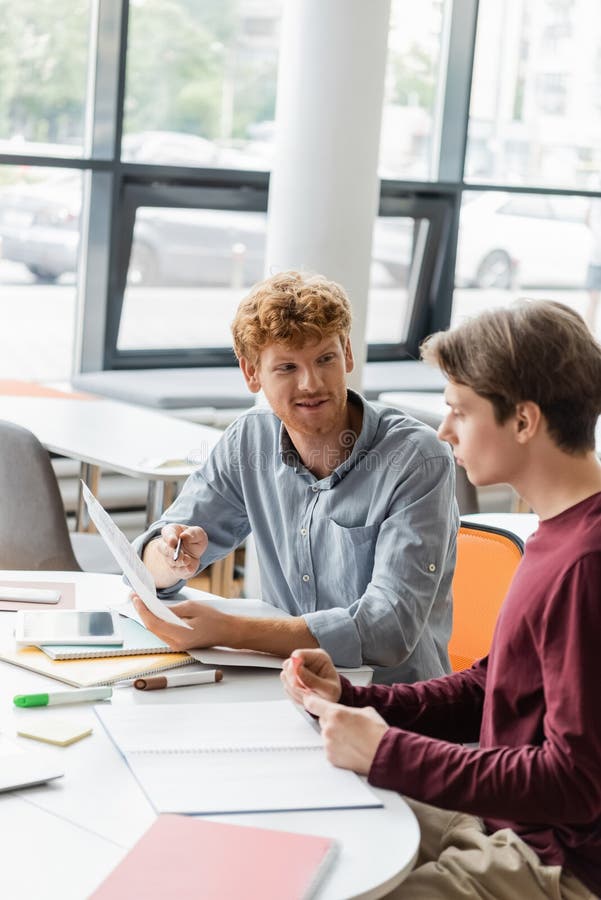 Young Male Students Engaged in Focused Stock Photo - Image of knowledge ...