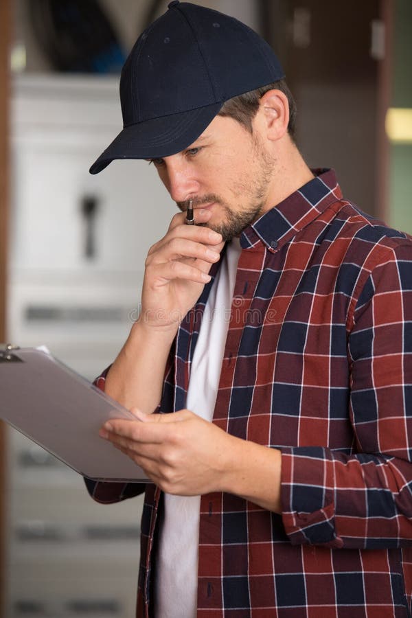 Young Male Supervisor Checking Checklist Stock Photo - Image of ...