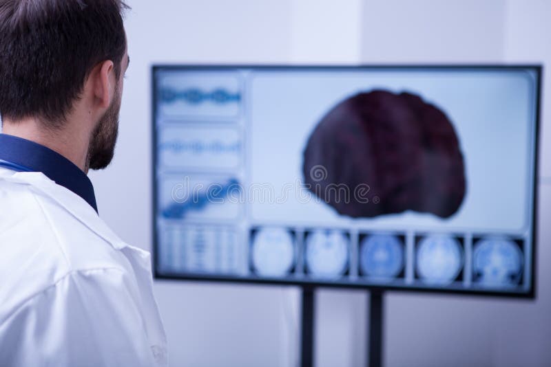 Young Male Surgeon Using Technology To Check Out a Patient Brain Stock ...