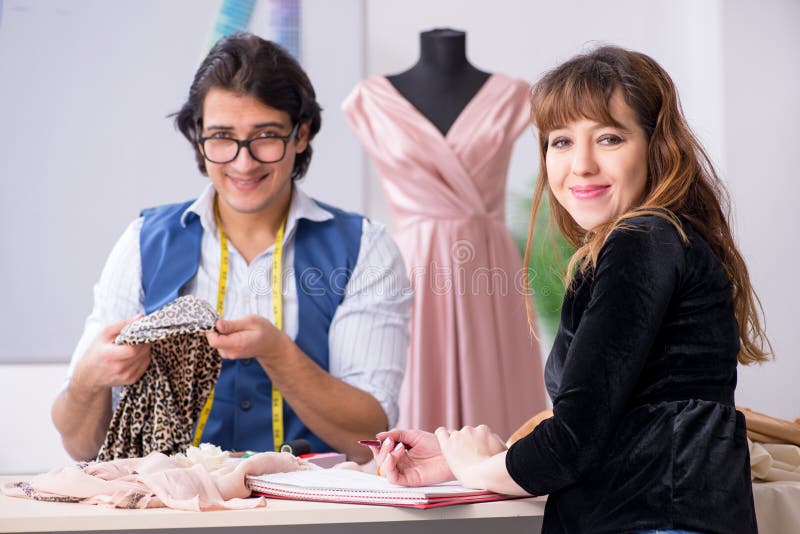 The Young Male Tailor Talking To Female Customer Stock Photo - Image of ...
