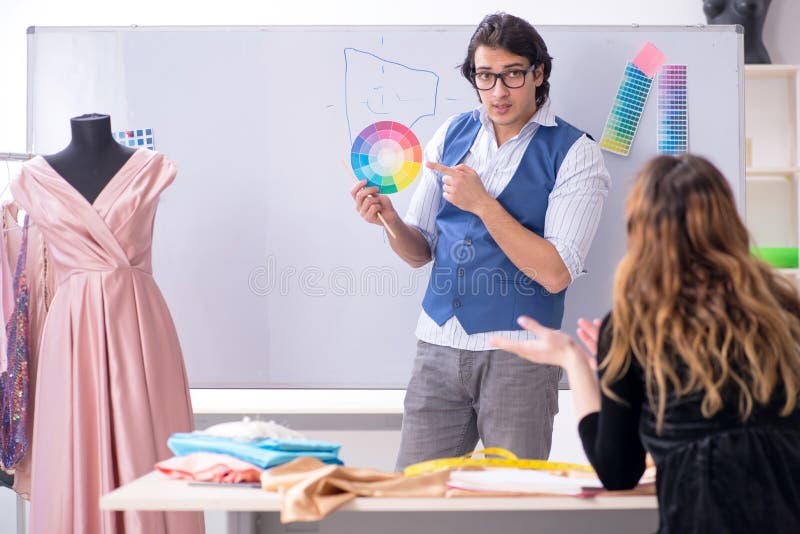 The Young Male Tailor Teaching Female Student Stock Photo - Image of ...