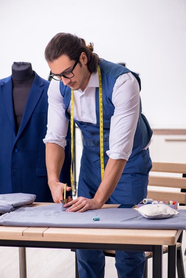 Young Male Tailor Working at Workshop Stock Photo - Image of measuring ...
